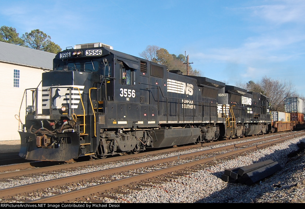 NS B32-8 # 3556 is back in the big time pulling a westbound.stacker about to cross Main St.